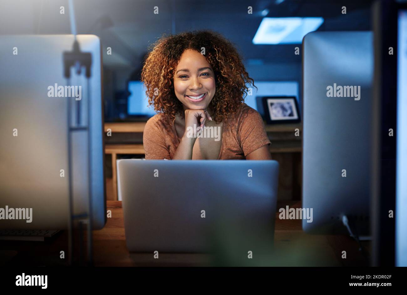 Shes a real night owl. Portrait of a young woman working late in an ...