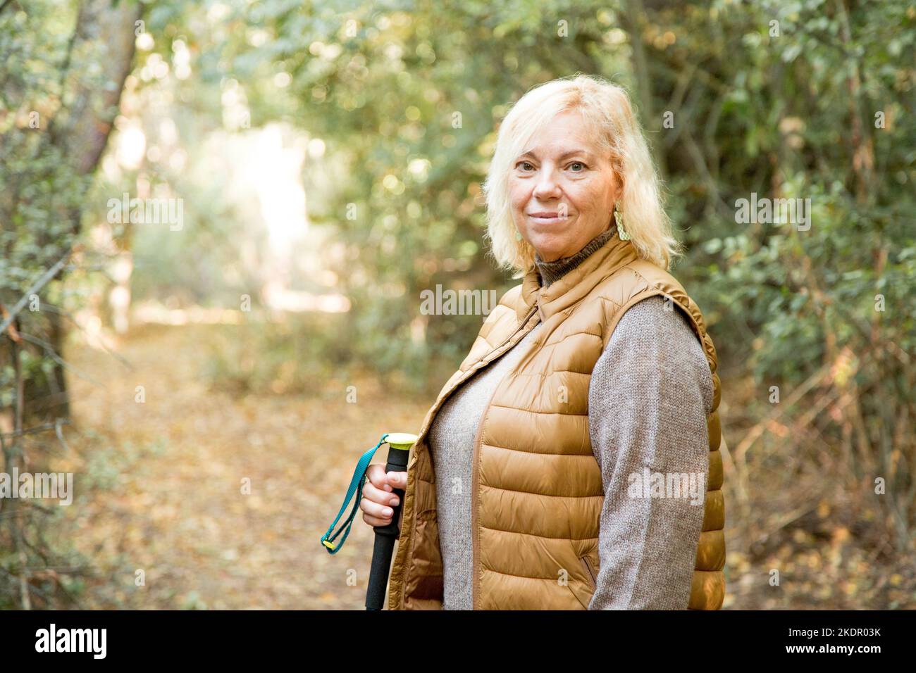 Portrait of a mature blond woman during a trekking in the forest Stock ...