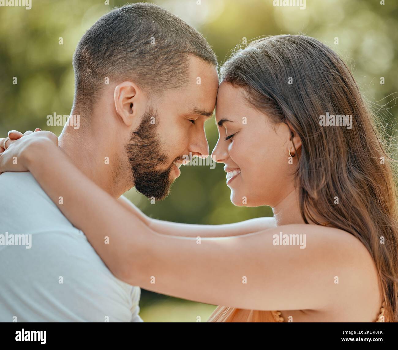 Couple, love and forehead touch in garden, summer park or outdoor ...