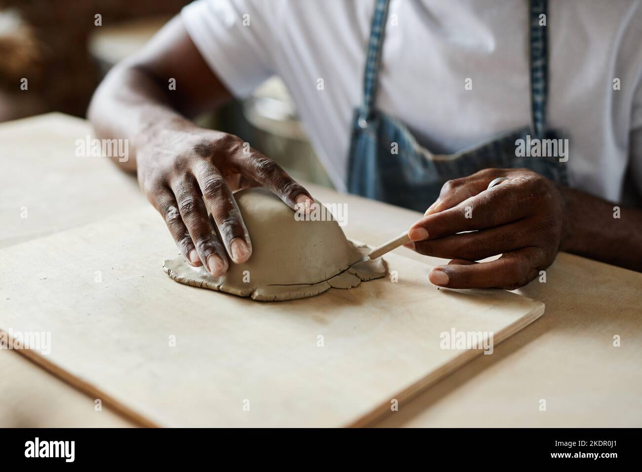 Close up of creative black man shaping ceramic bowl in cozy pottery ...
