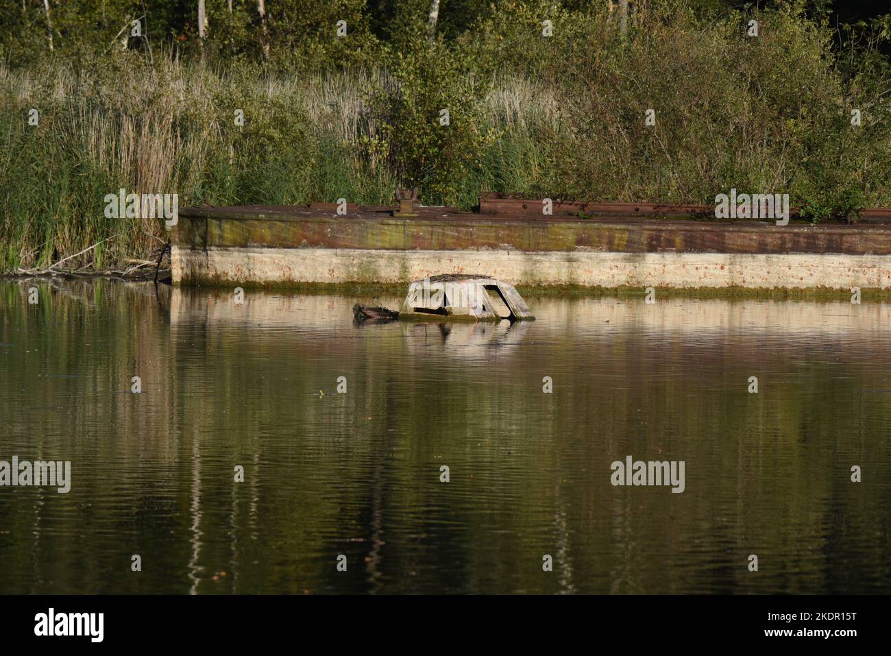 A sunken boat peeps out of the water at Greatbottom Flash along the ...