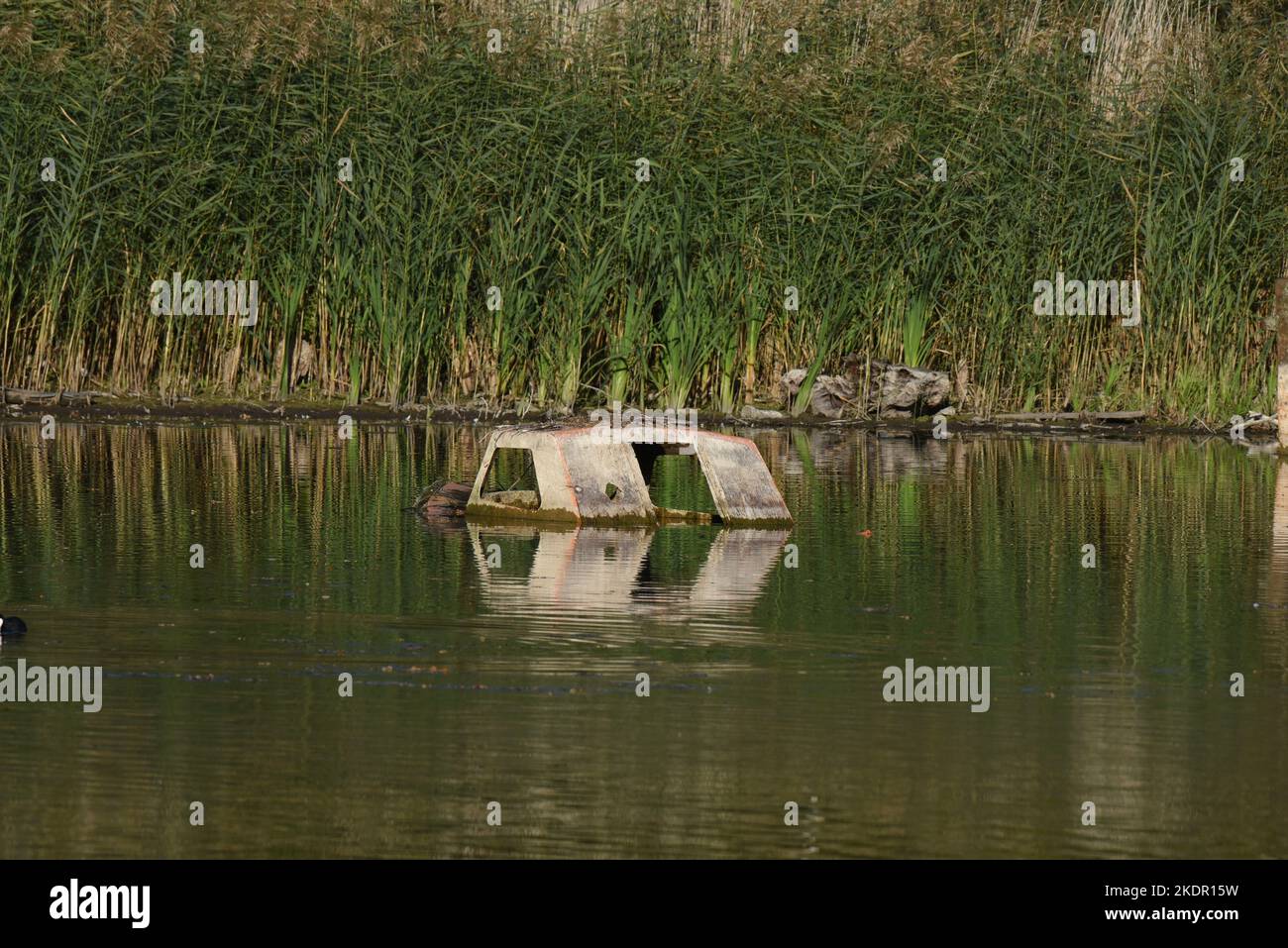 A sunken boat peeps out of the water at Greatbottom Flash along the ...