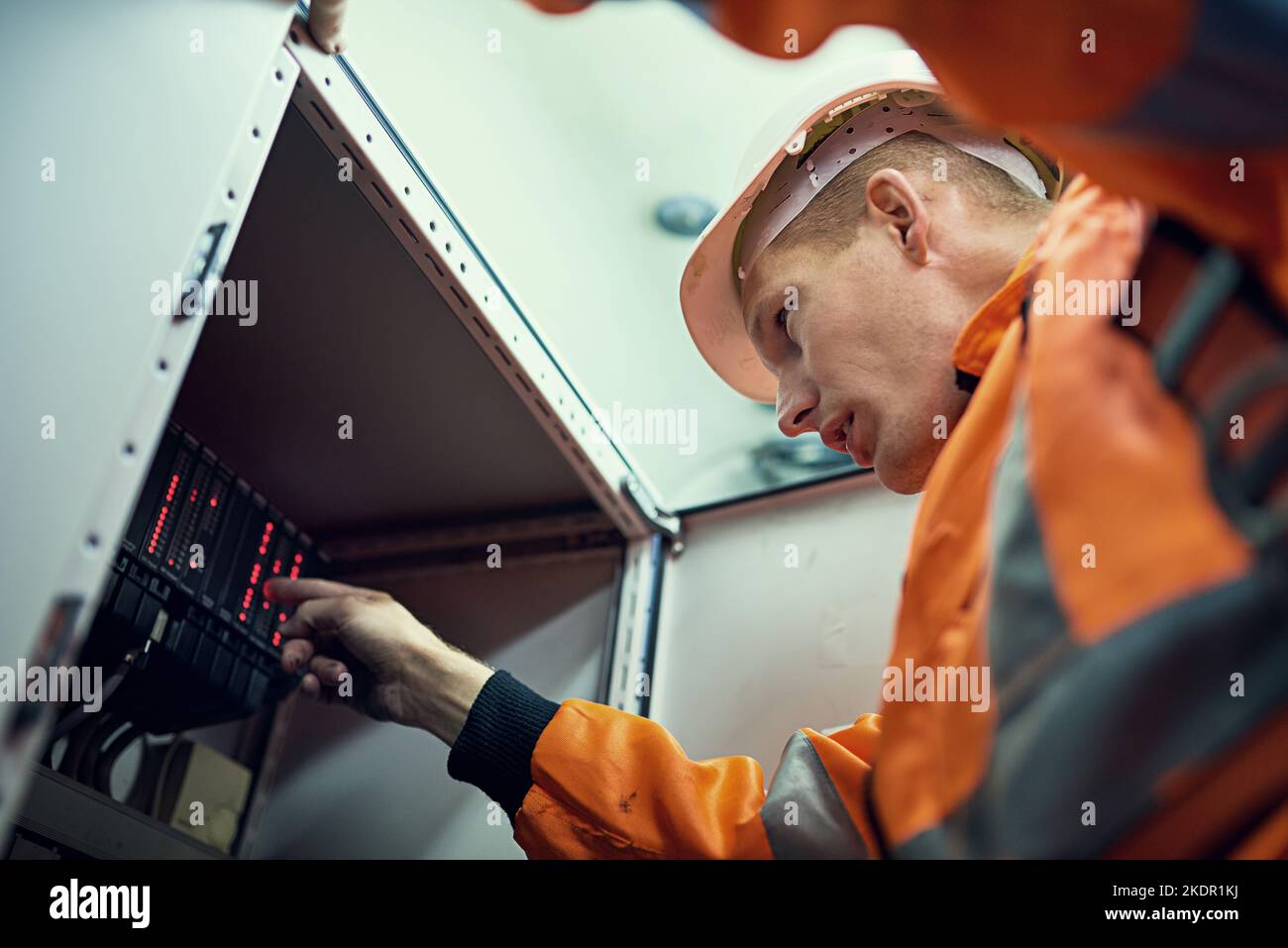Regular maintenance is a key part of his job. a young engineer working ...