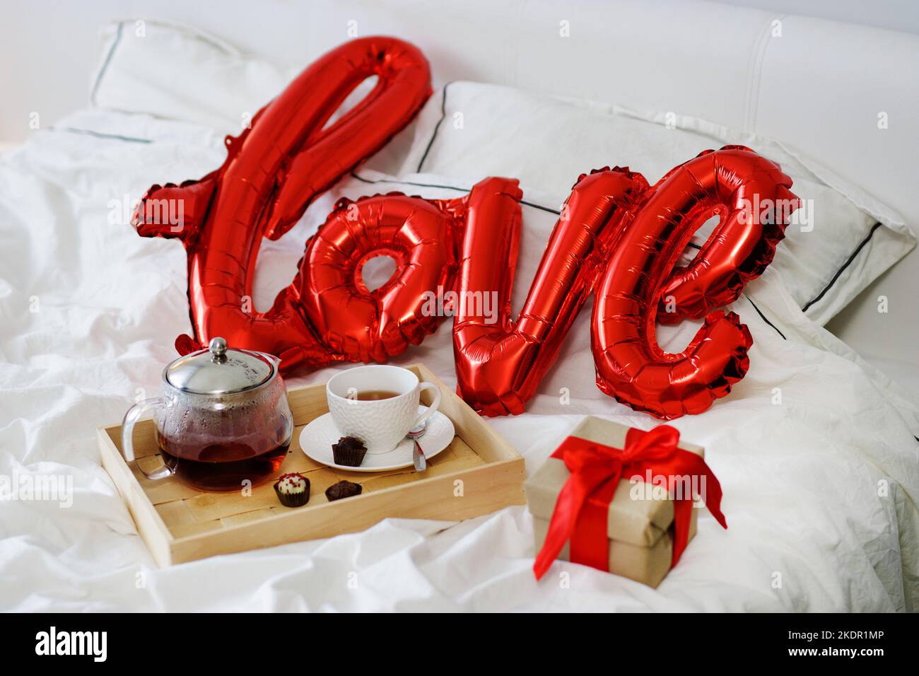 Valentine's day and romantic concept - wooden tray with cup of tea ...