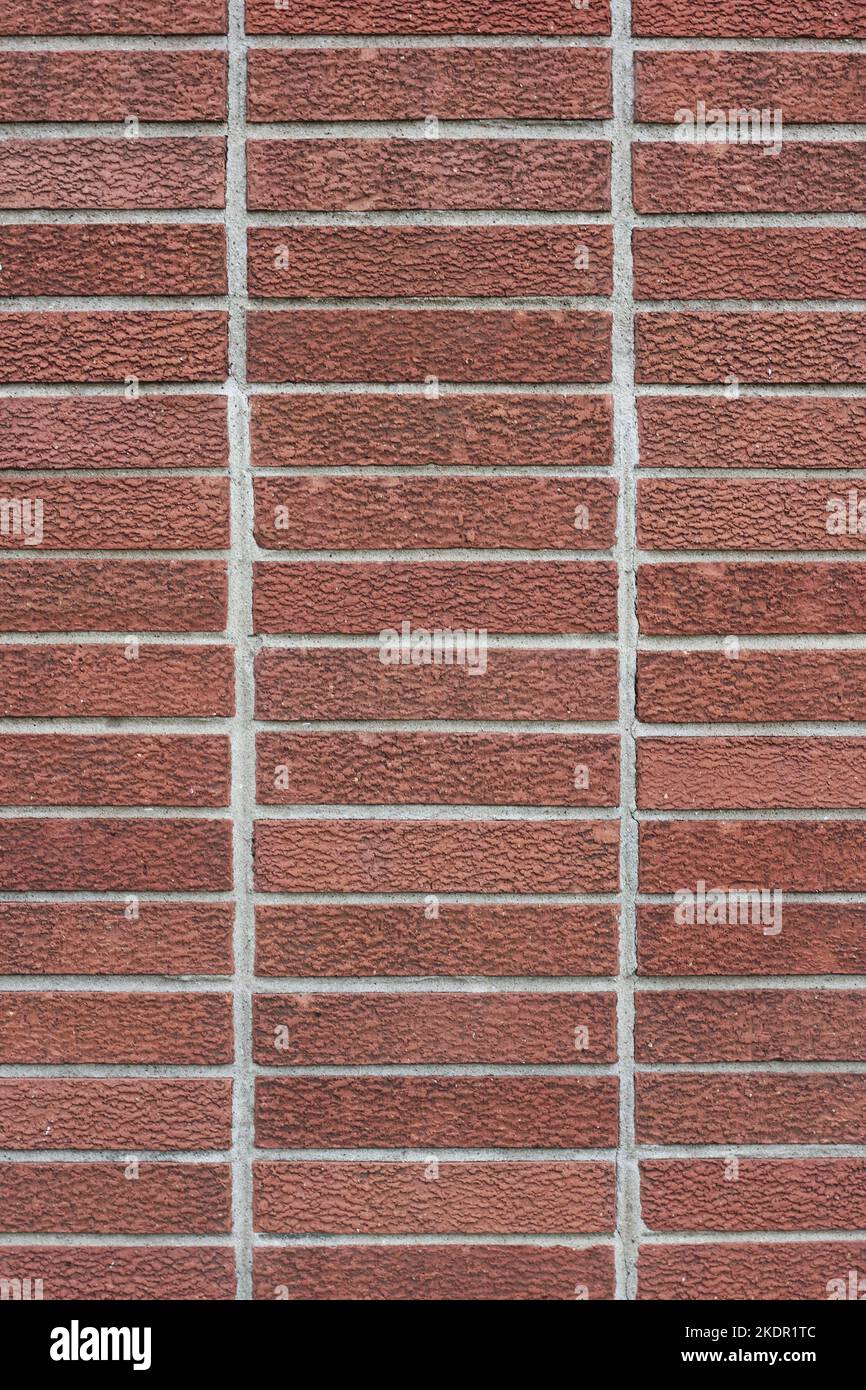 Full frame view of a rectangular red brick wall with an even repeating ...