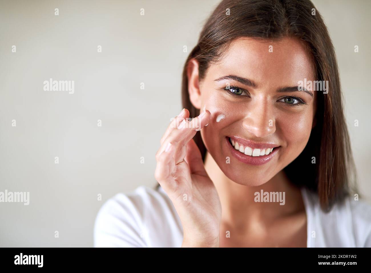 Moisture Is My Beauty Secret Portrait Of A Beautiful Woman Applying