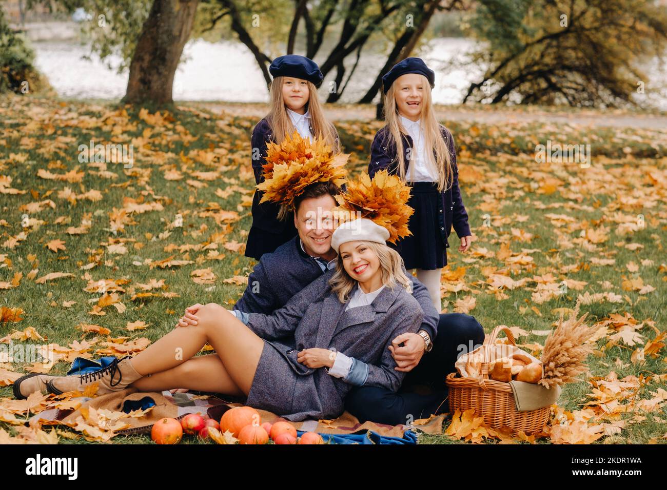 A big family on a picnic in the fall in a nature park. Happy people in ...