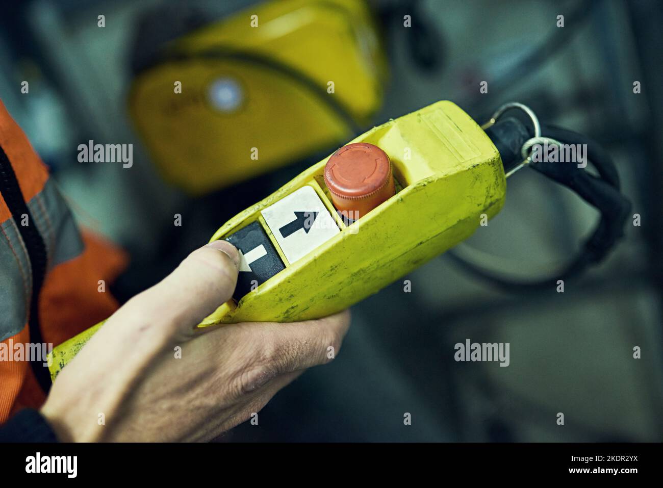 The ominous red button. an unidentifiable engineer holding a control ...