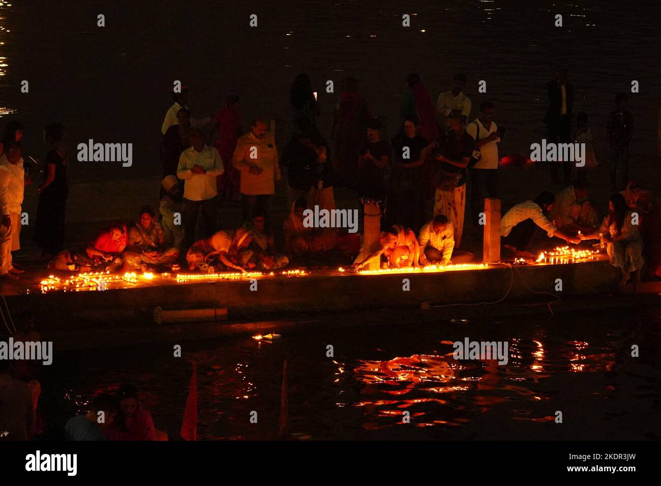 Indian Hindu devotee lights up traditional oil lamps to celebrate Dev ...