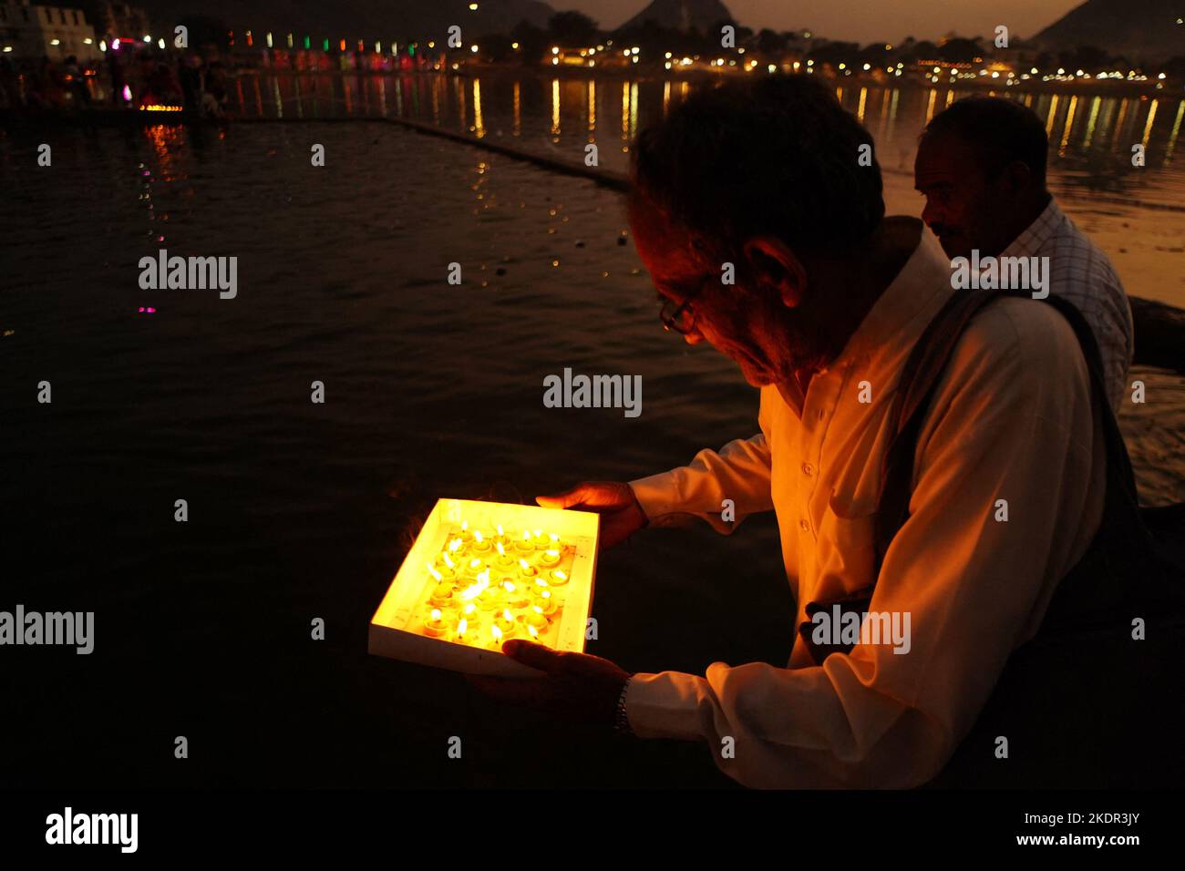 Indian Hindu devotee lights up traditional oil lamps to celebrate Dev ...