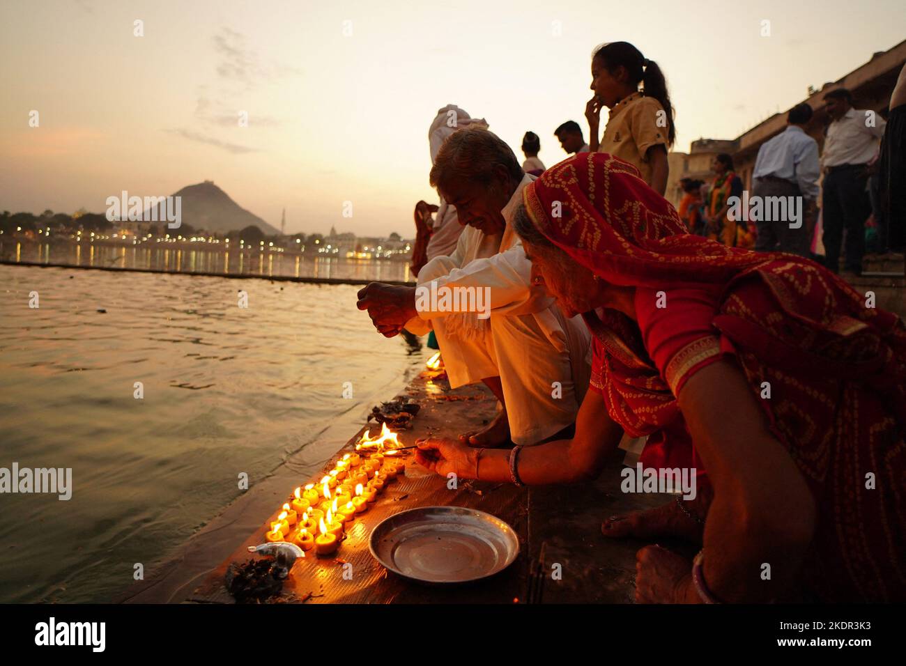Indian Hindu devotee lights up traditional oil lamps to celebrate Dev ...