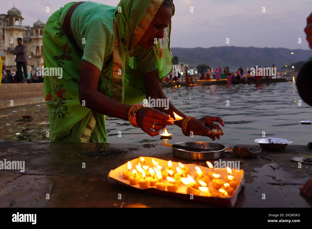 Indian Hindu devotee lights up traditional oil lamps to celebrate Dev ...