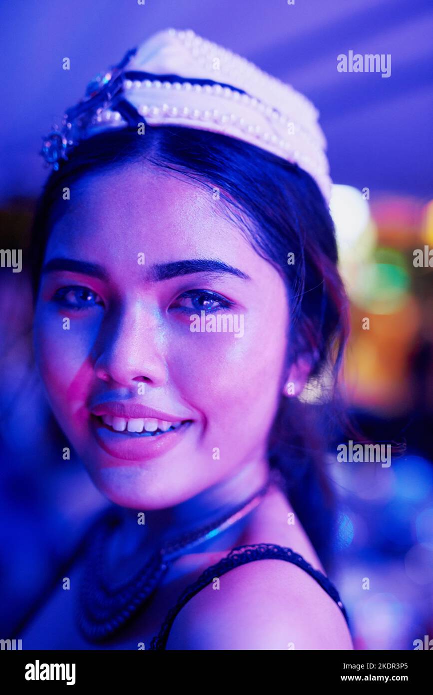 The face of exploitation. Portrait of a young woman working in a neon ...