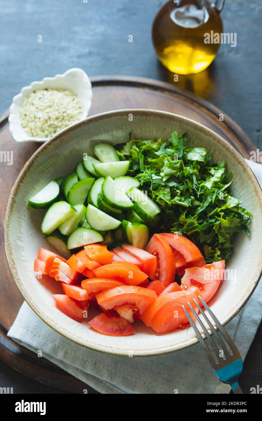 fresh salad with tomatoes, cucumbers, herbs and hemp seeds Stock Photo ...