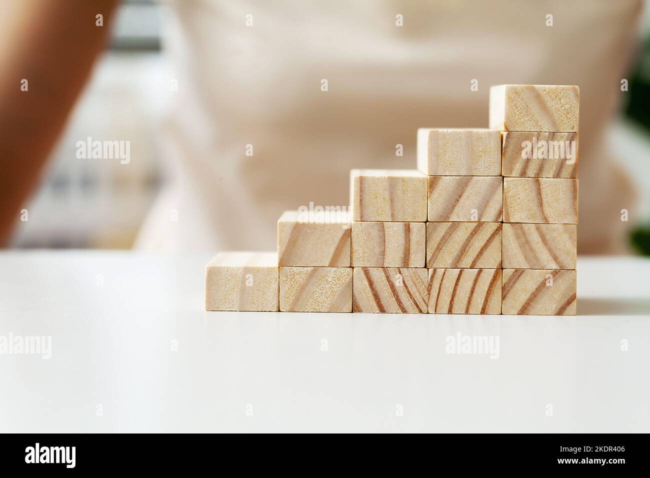 Female hand arranging wood block stacking as step stair Stock Photo - Alamy