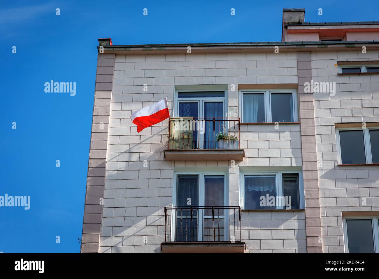 Polish flag on a balcony of residential building in Warsaw, capital of ...