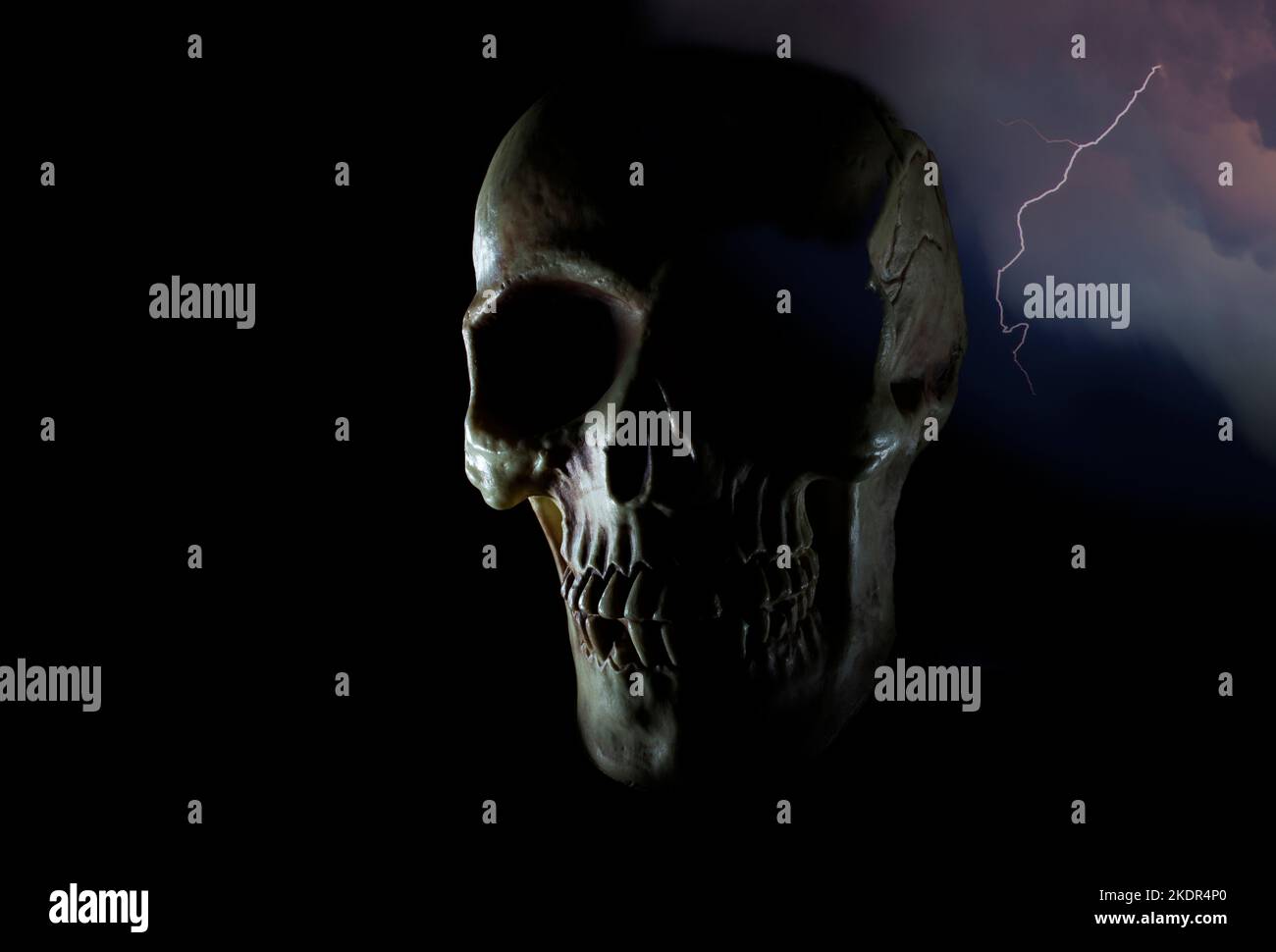 Copy space around a human skull with lightning behind Stock Photo - Alamy