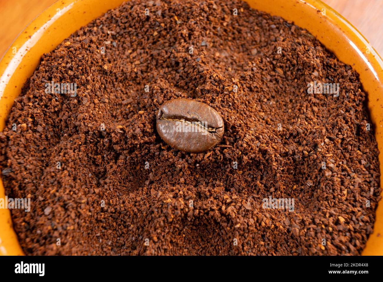 Ground coffee ready for brewing, top view of coffee, one bean lying on ...