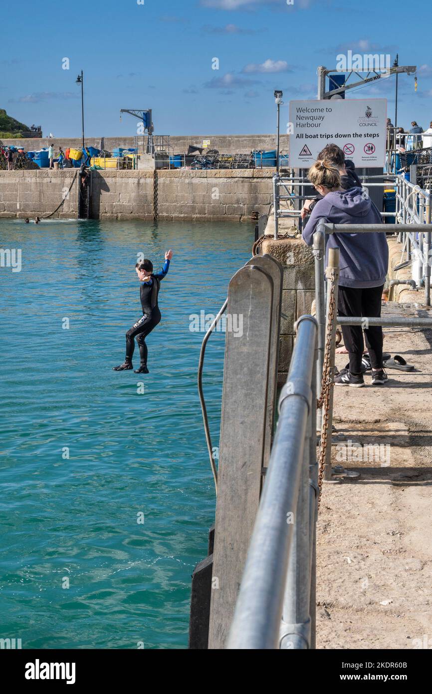 Young teenagers jumping tombstoning into the sea at high tide from the ...