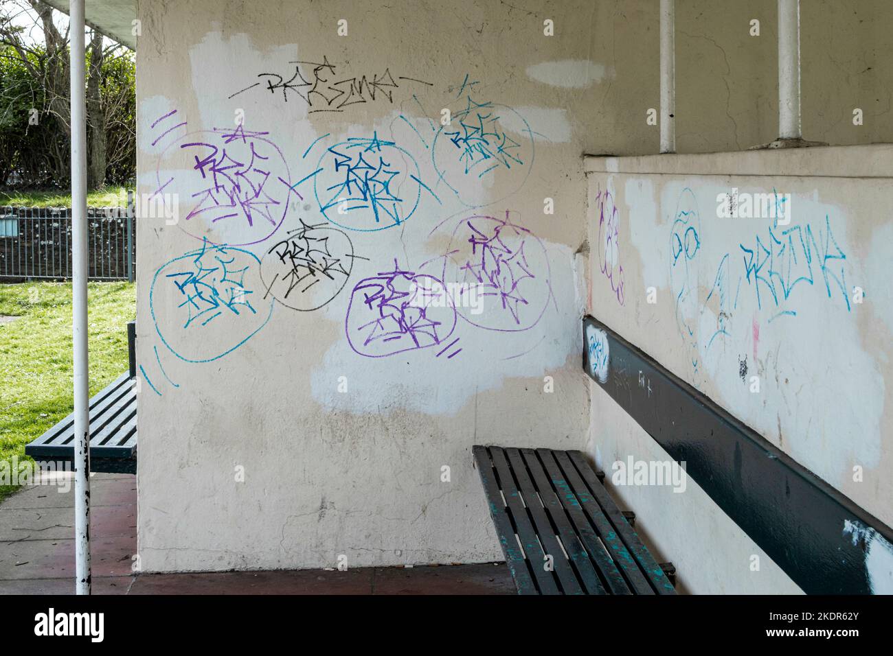 Graffiti tags defacing a wall in a shelter in Newquay in Cornwall in ...