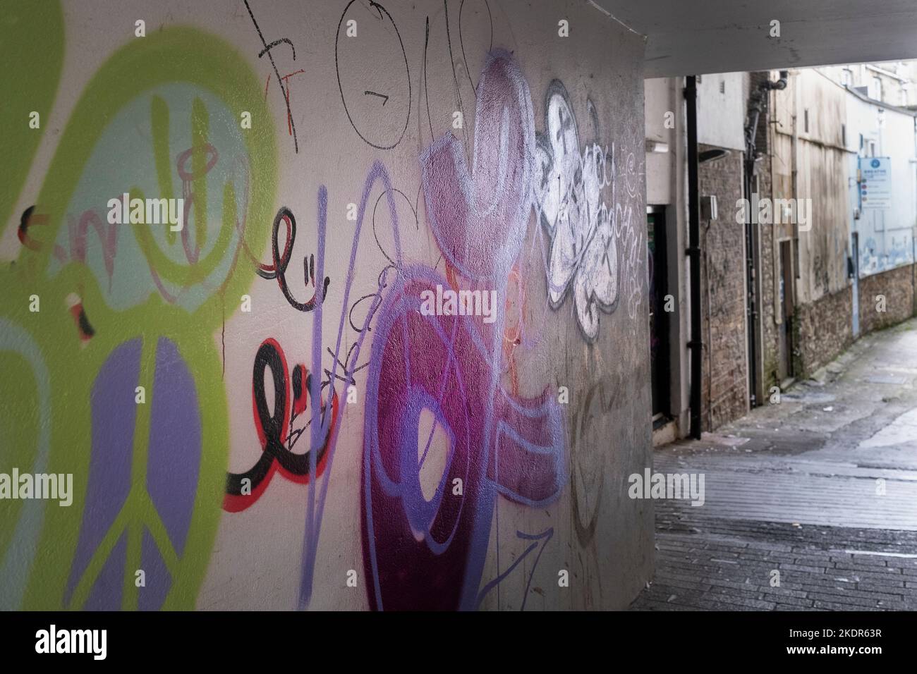 Tags graffiti sprayed over a wall in Roberts Ope an old alleyway in ...