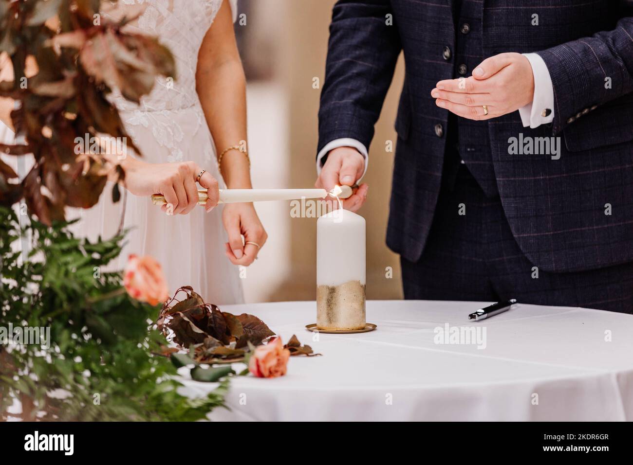 Bride and groom lighting Unity candle at Humanist wedding ceremony to ...