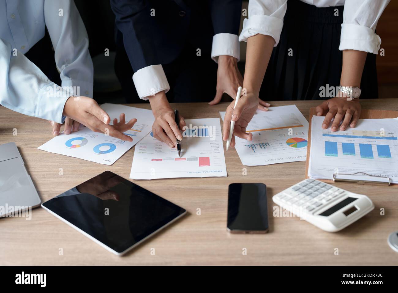 Group business use calculators, documents, computers to analyze work ...