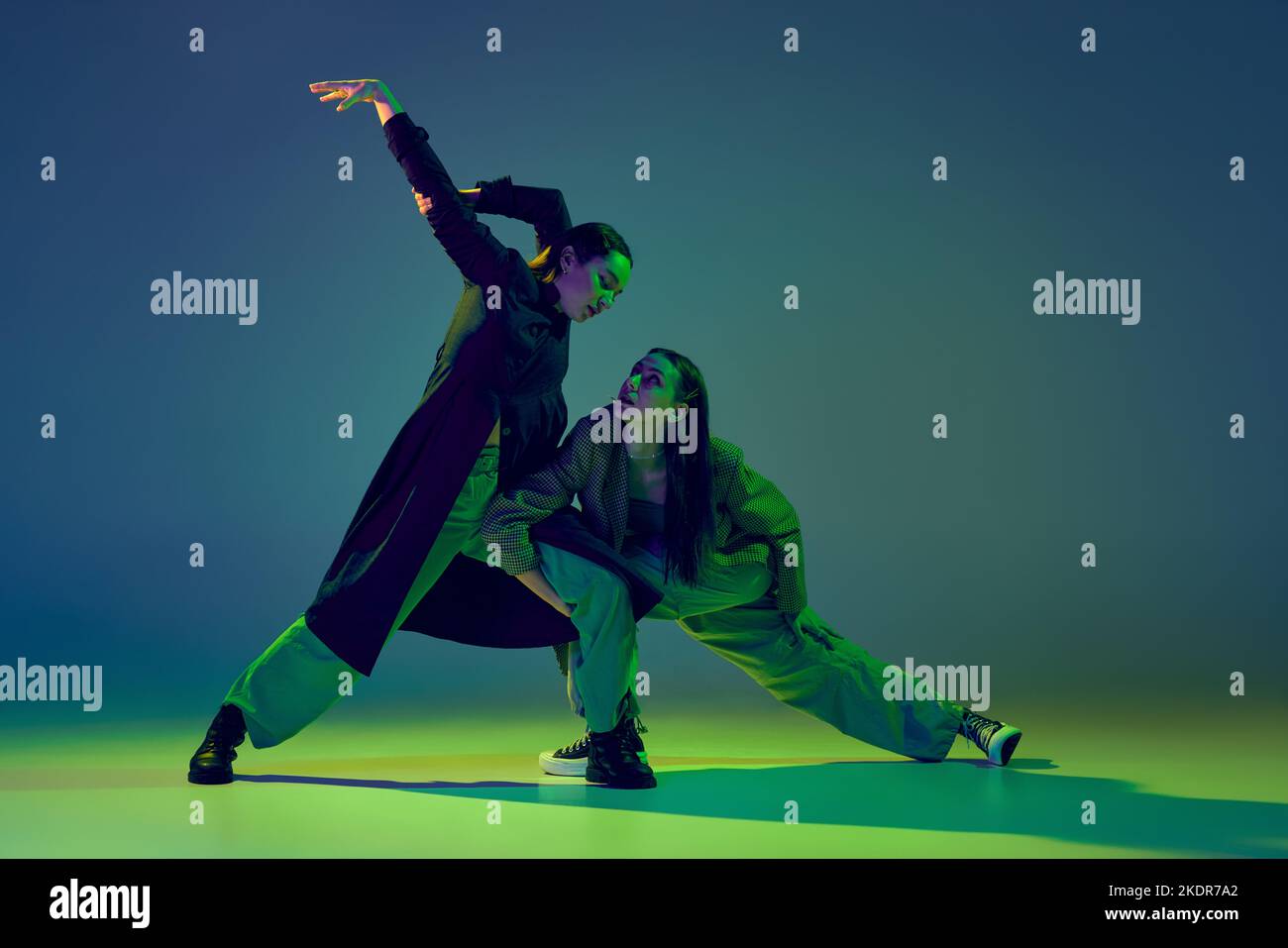 Emotions. Stylish young girls in casual clothes dancing experimental ...