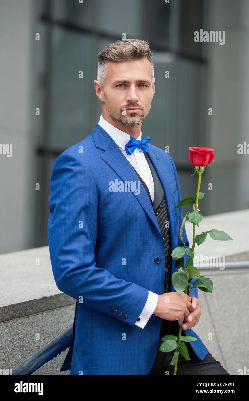 valentines day concept. tuxedo man with valentines rose. flower gift ...