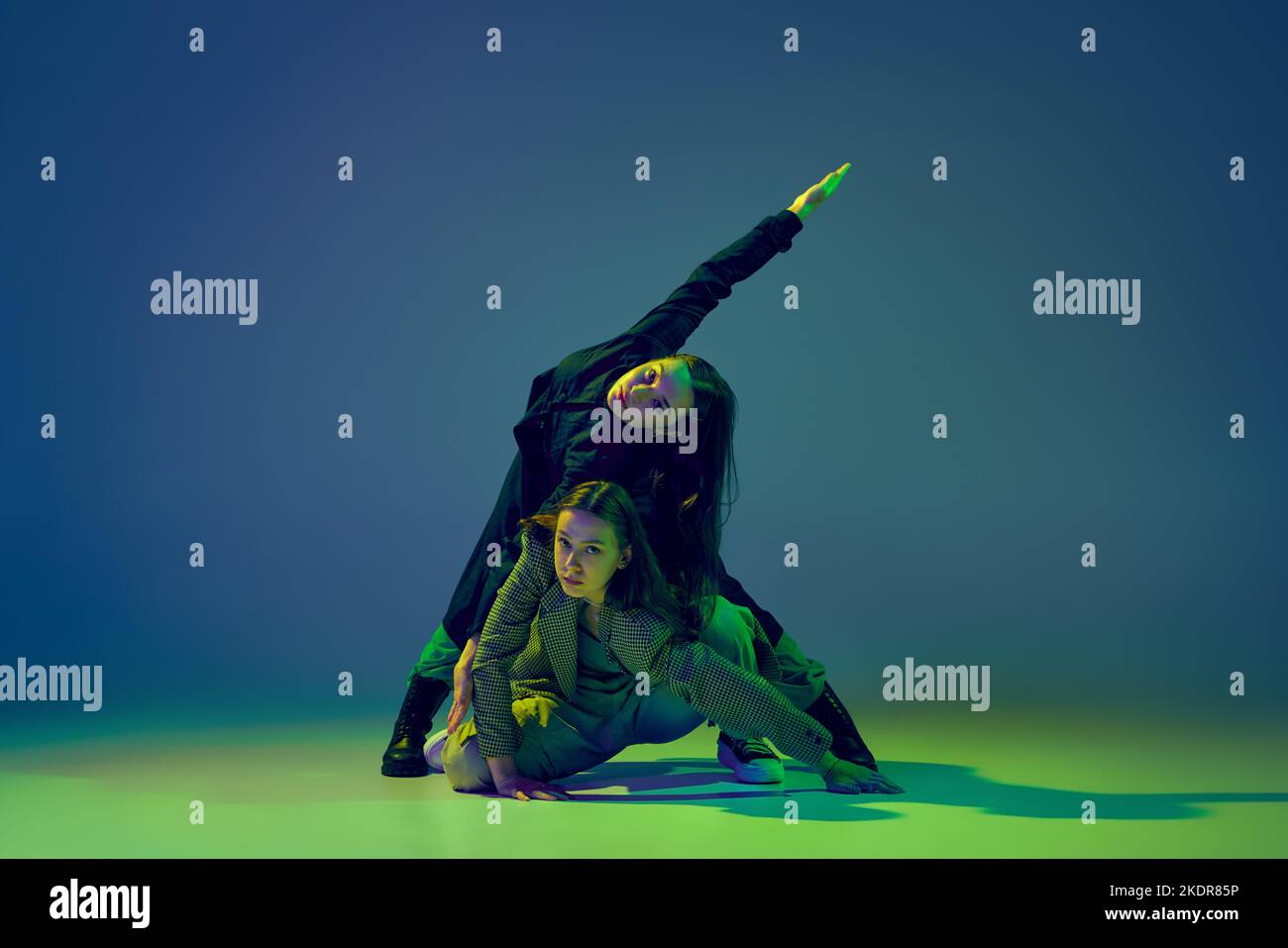 Weird. Stylish young girls in casual clothes dancing experimental style ...