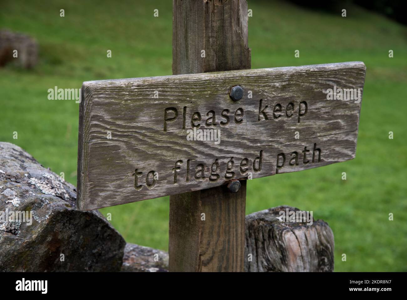 Wooden sign "Please keep to the flagged Path" in the Swaledale in the ...