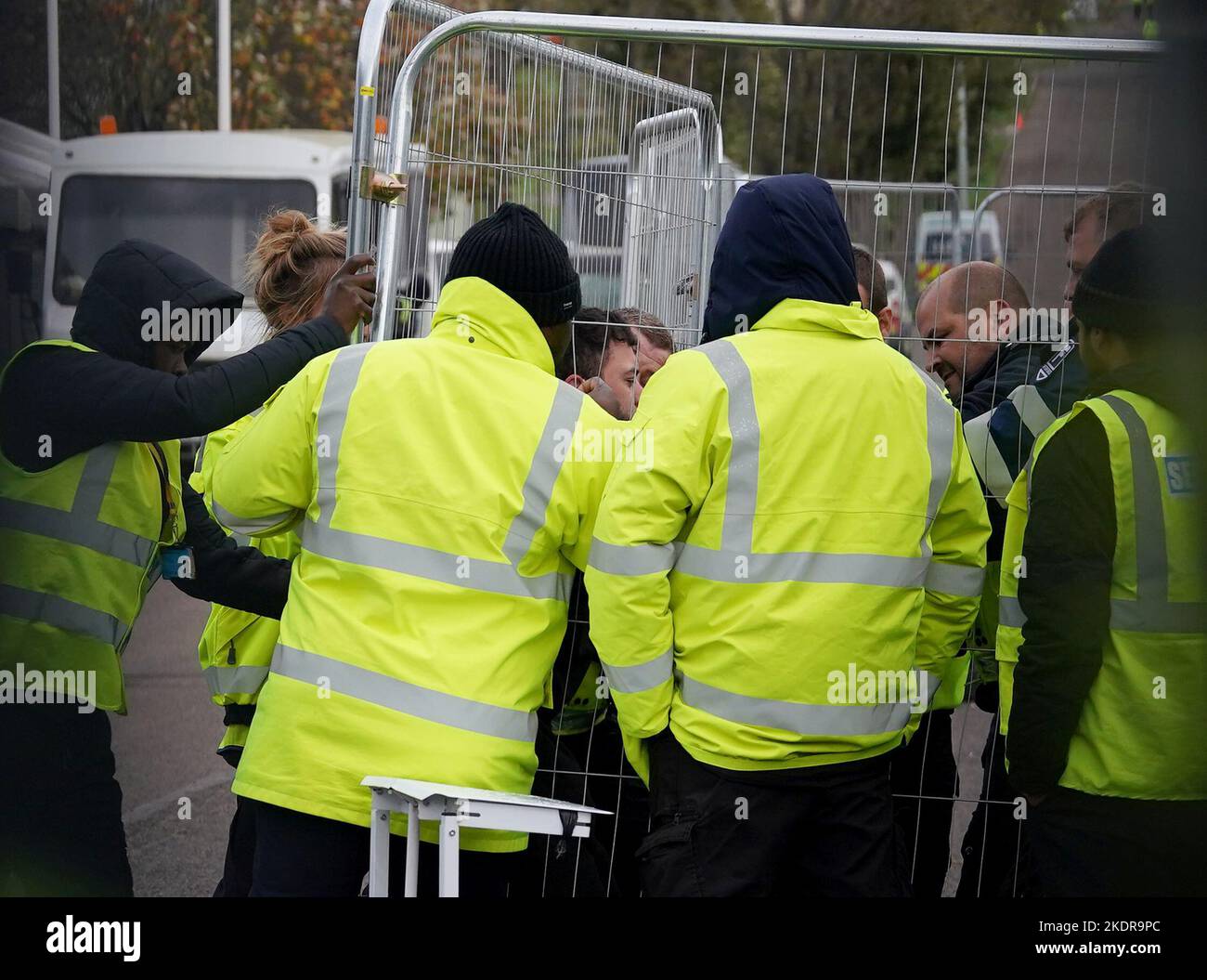 A migrant attempting to communicate with journalists is pinned against ...