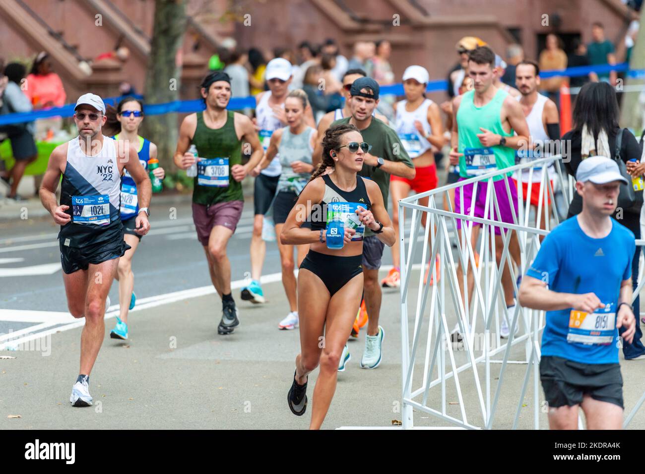 Runners pass through Harlem in New York near the 22 mile mark near ...