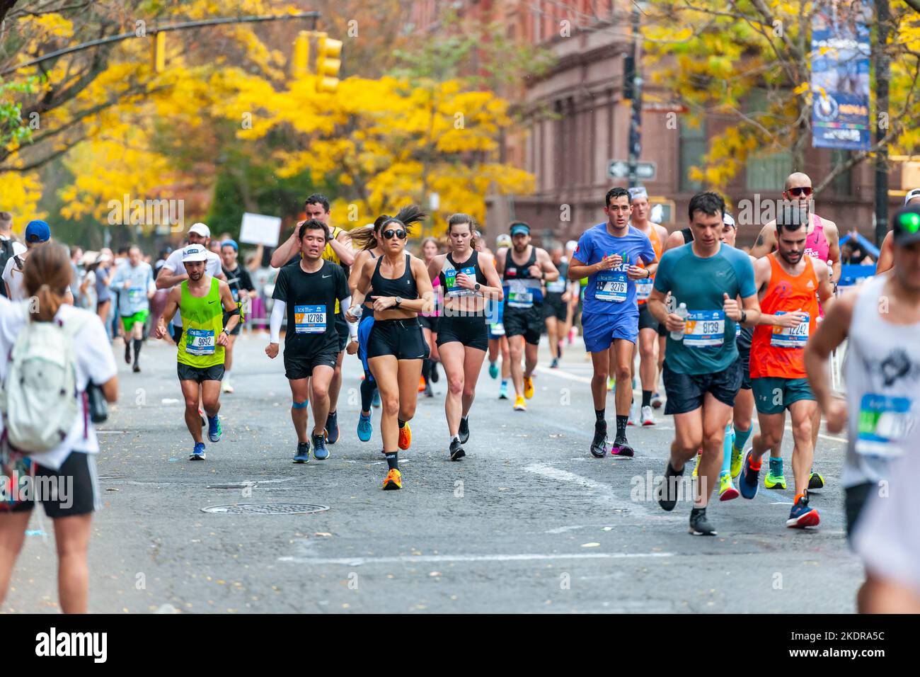 Runners pass through Harlem in New York near the 22 mile mark near ...
