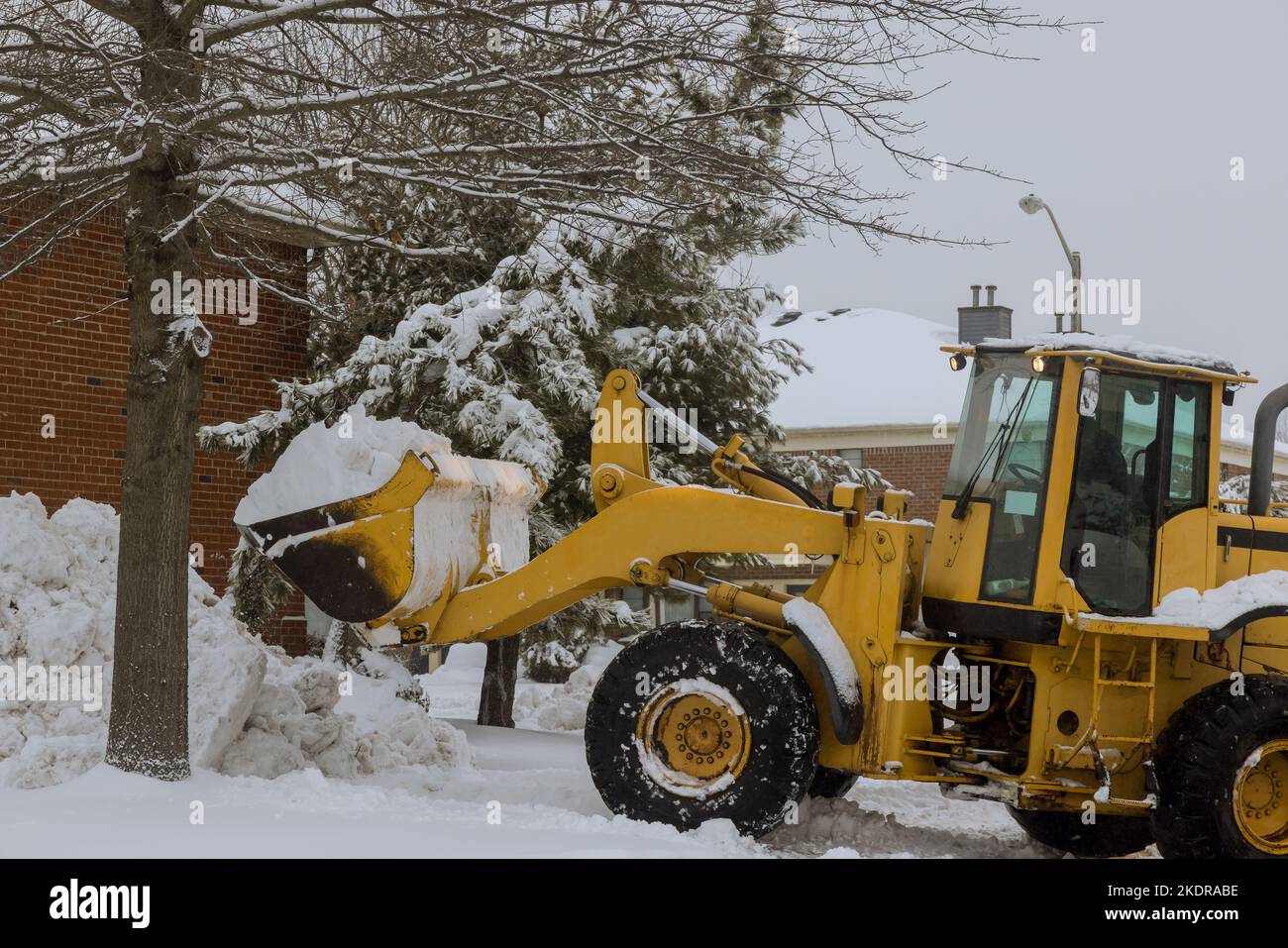 Clean up of snow with tractor after big snowstorm in winter after snow ...