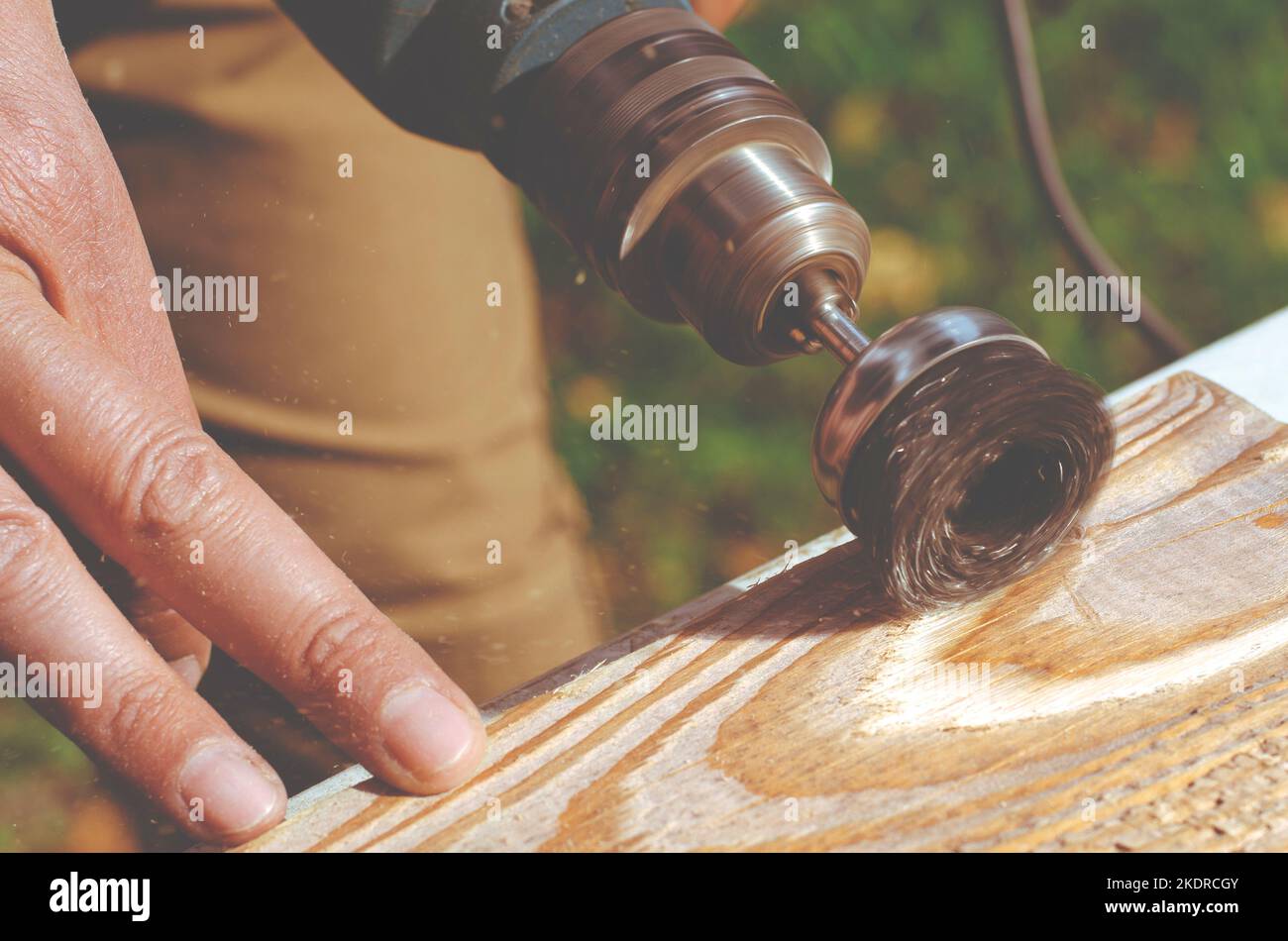 Male hand is holding brushing machine electrical rotating with metal ...