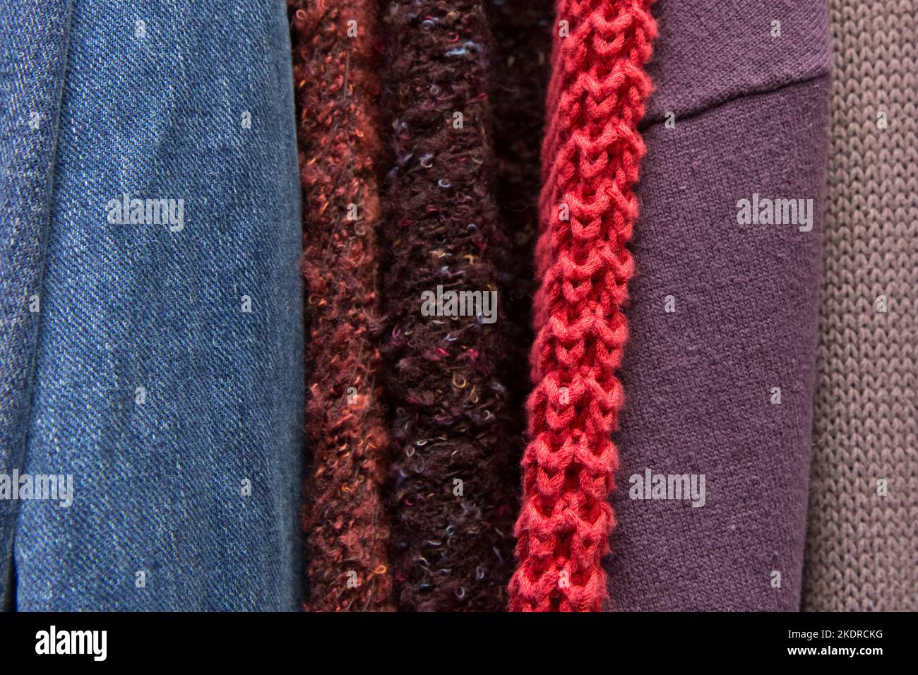 Set of different colored fabric clothes vintage textile background ...