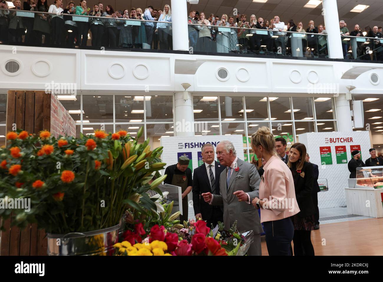 King Charles III speaks with members of staff during a visit to the ...