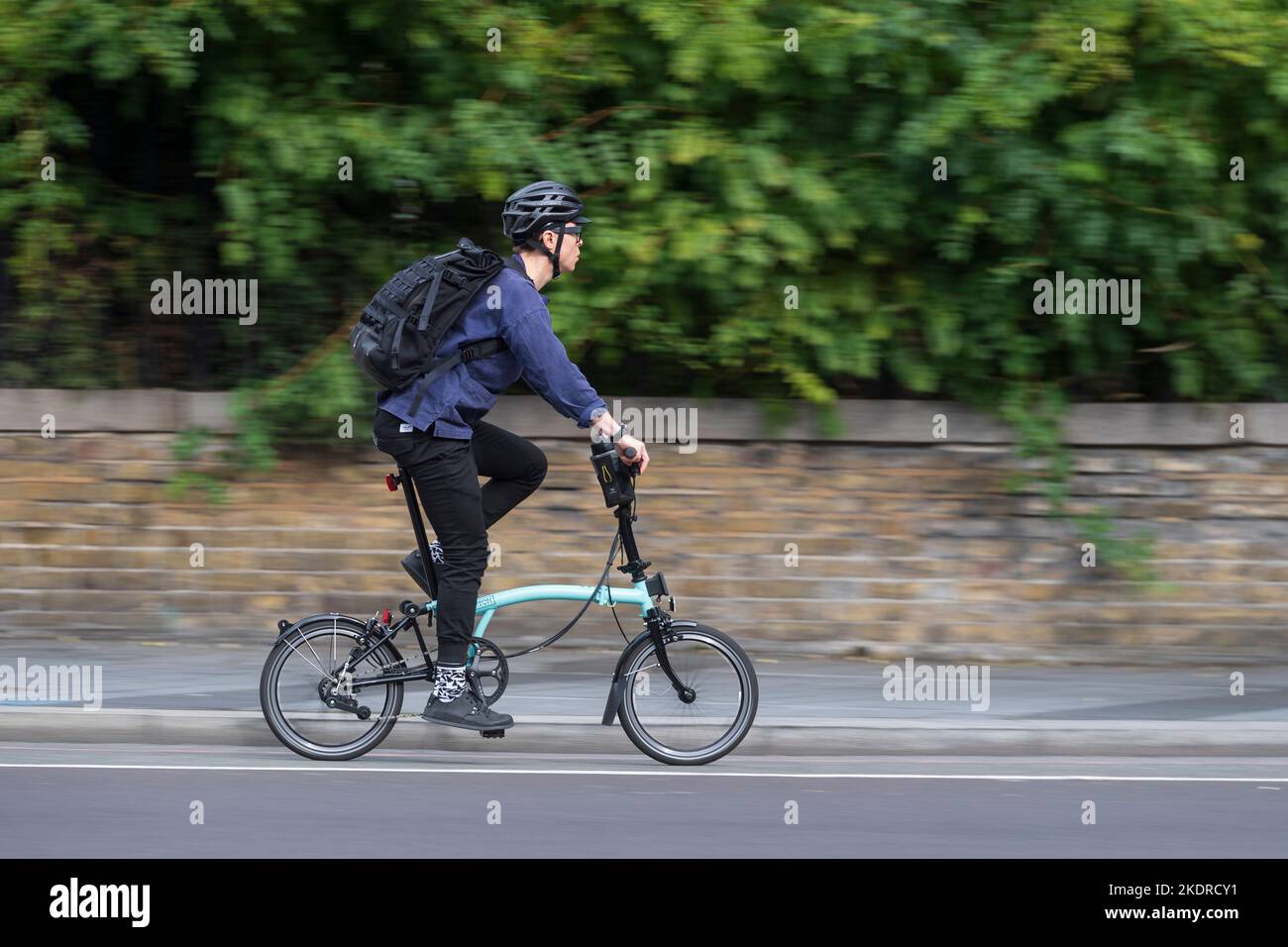 A man riding a Brompton folding bicycle along Waterloo Road, London, UK ...