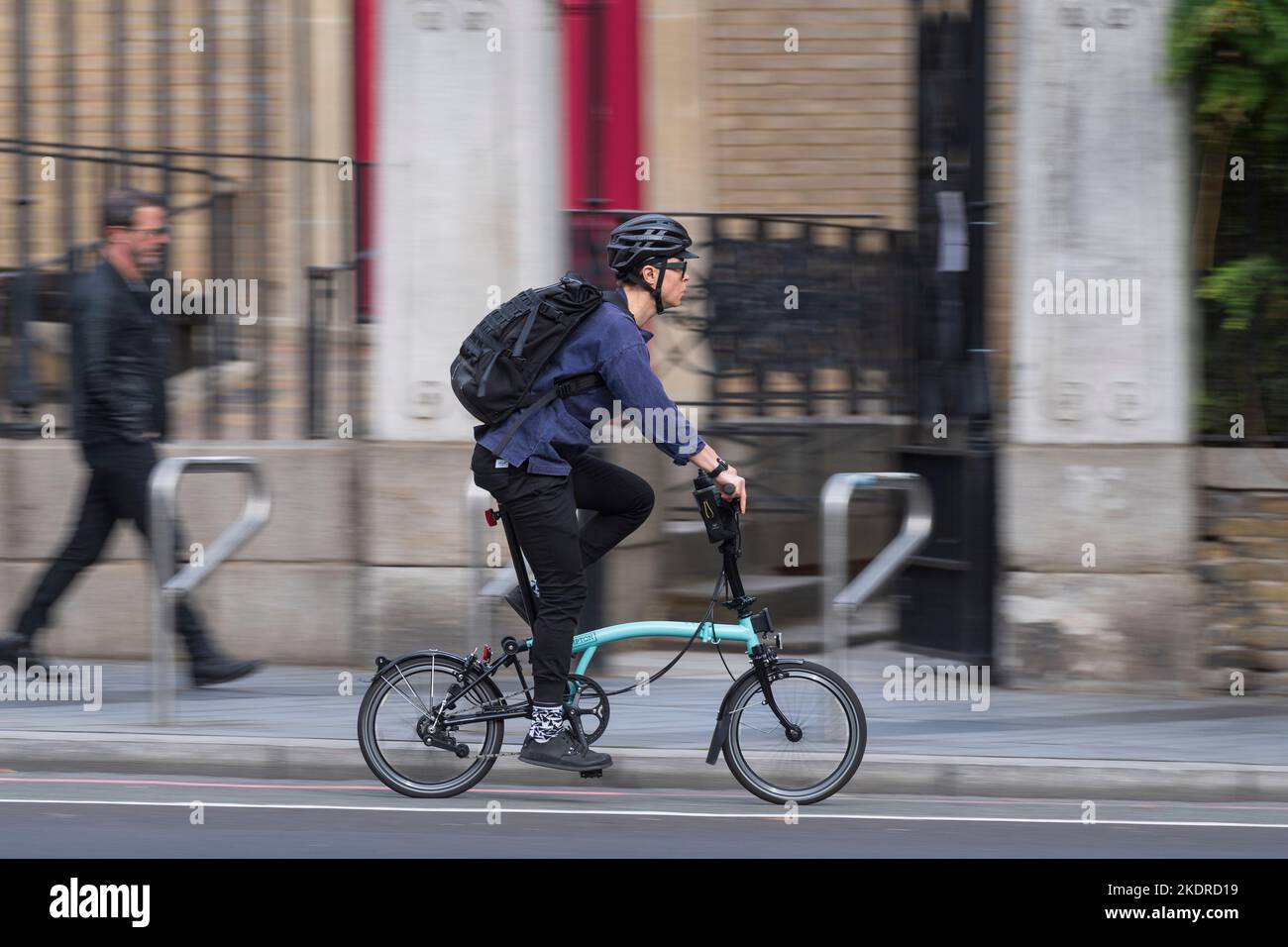 A man riding a Brompton folding bicycle along Waterloo Road, London, UK ...