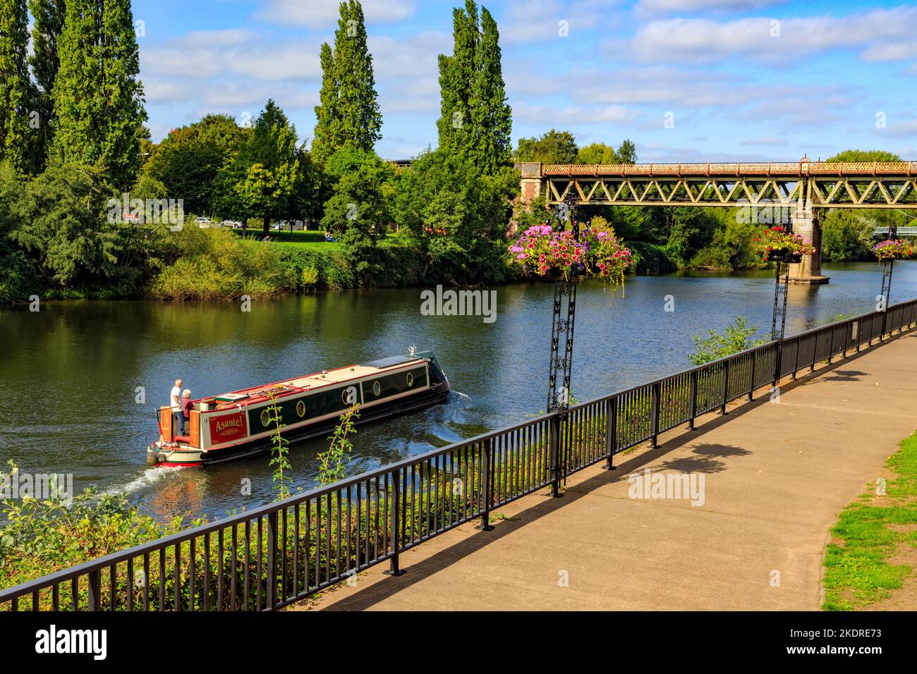 A narrow boat makes it way up the River Severn through Worcester, Worcestershire, England, UK ...