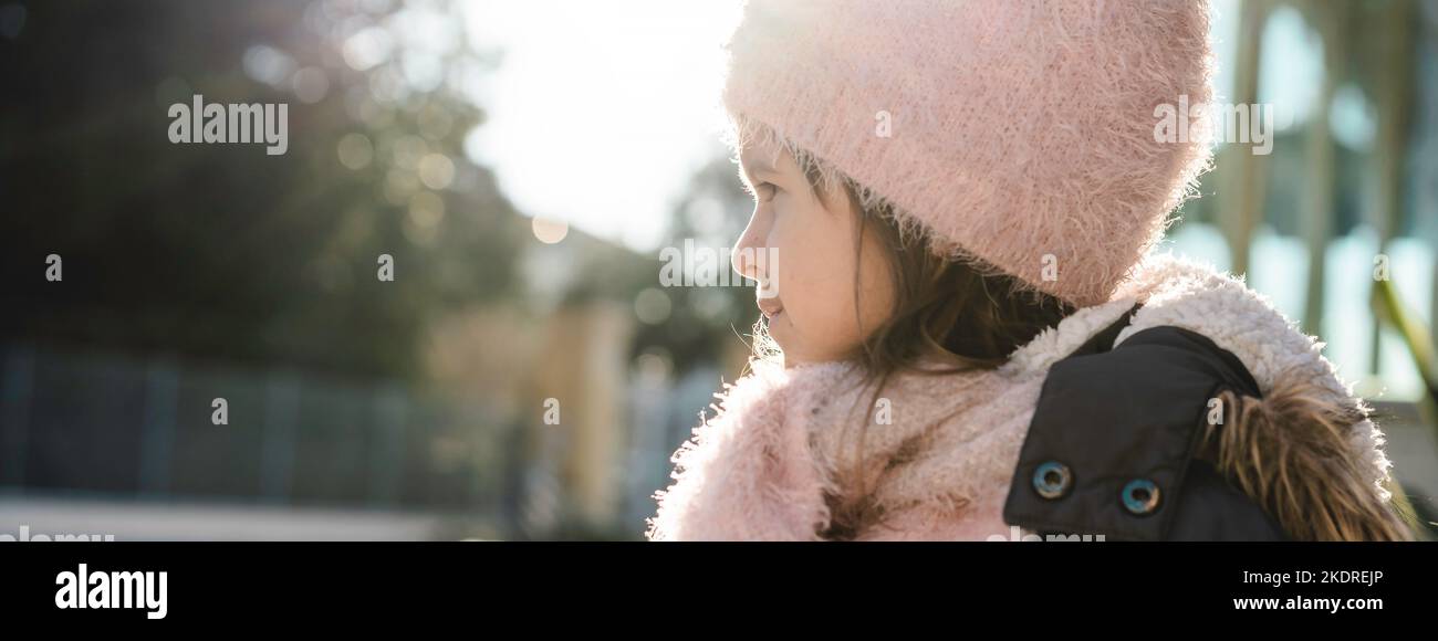 horizontal banner with pensive girl child wearing winter clothes ...