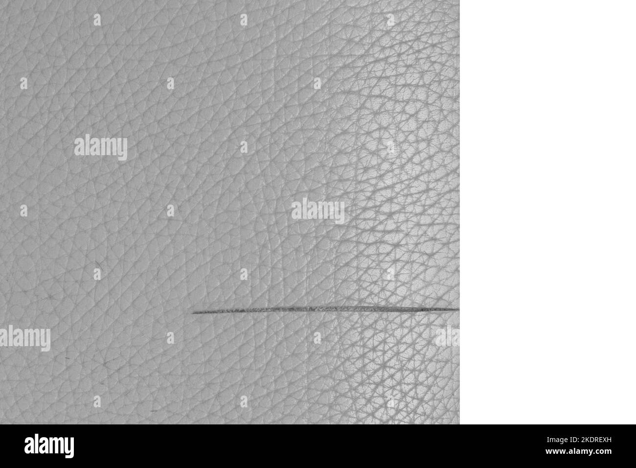 Cut on leather grey material torn old vintage textile damaged on white ...