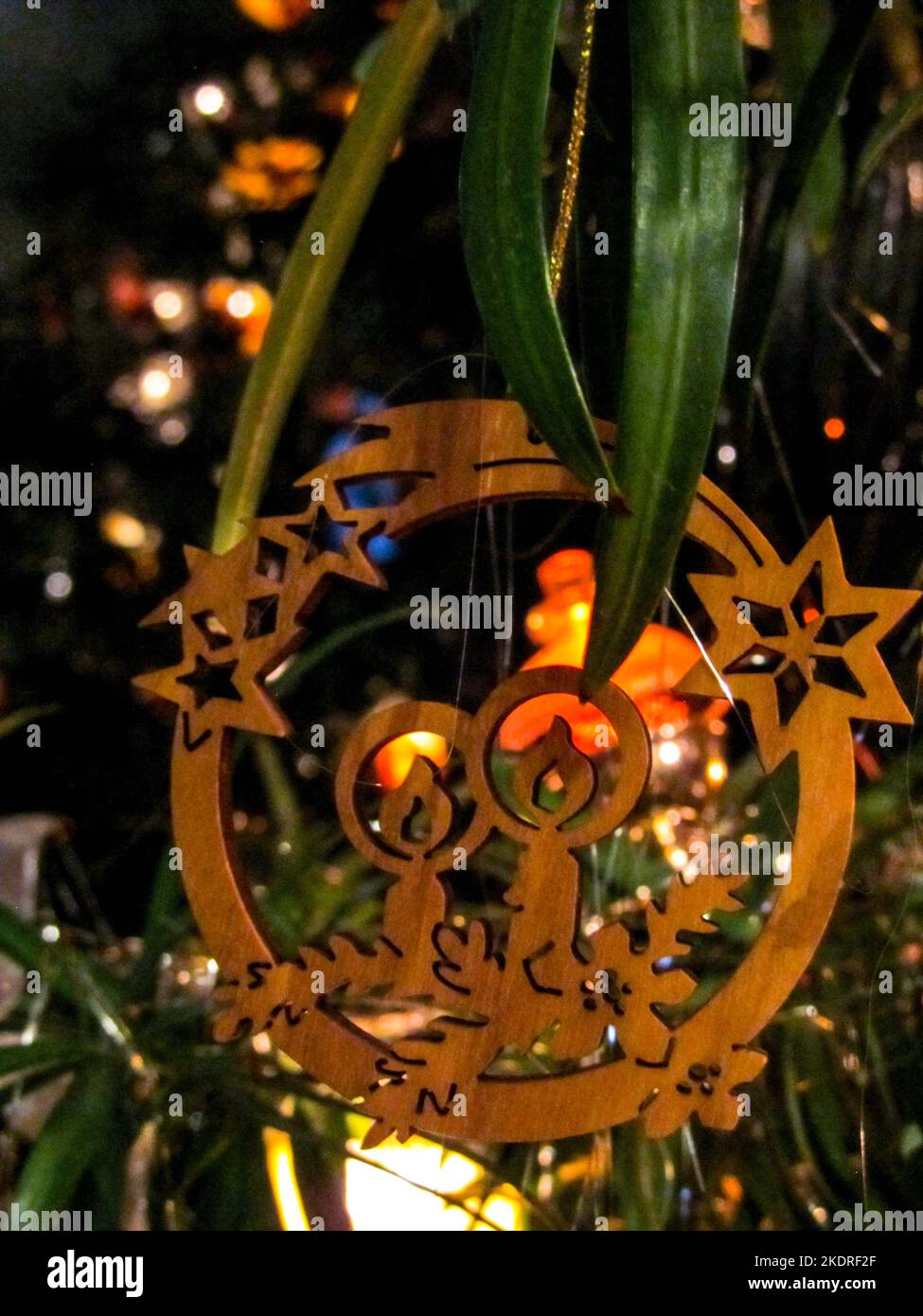 A simplistic wooden Christmas tree decoration depicting candles, with a ...