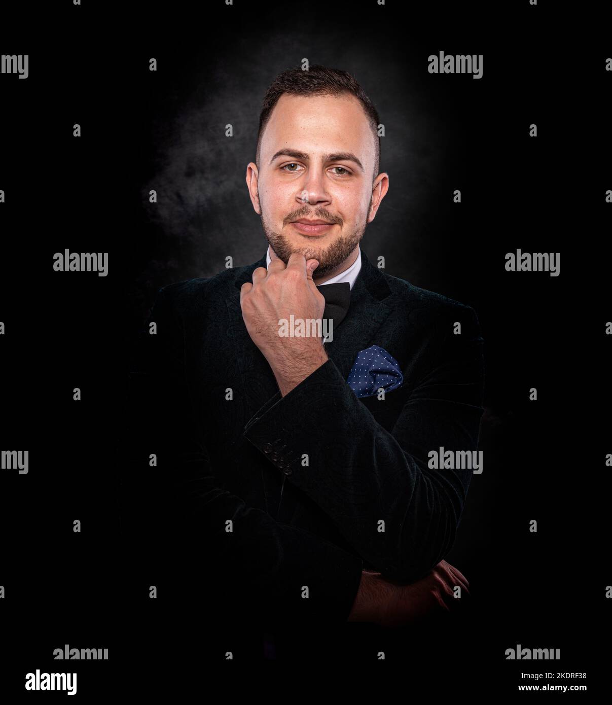 Attractive man with a beard on a dark background Stock Photo - Alamy