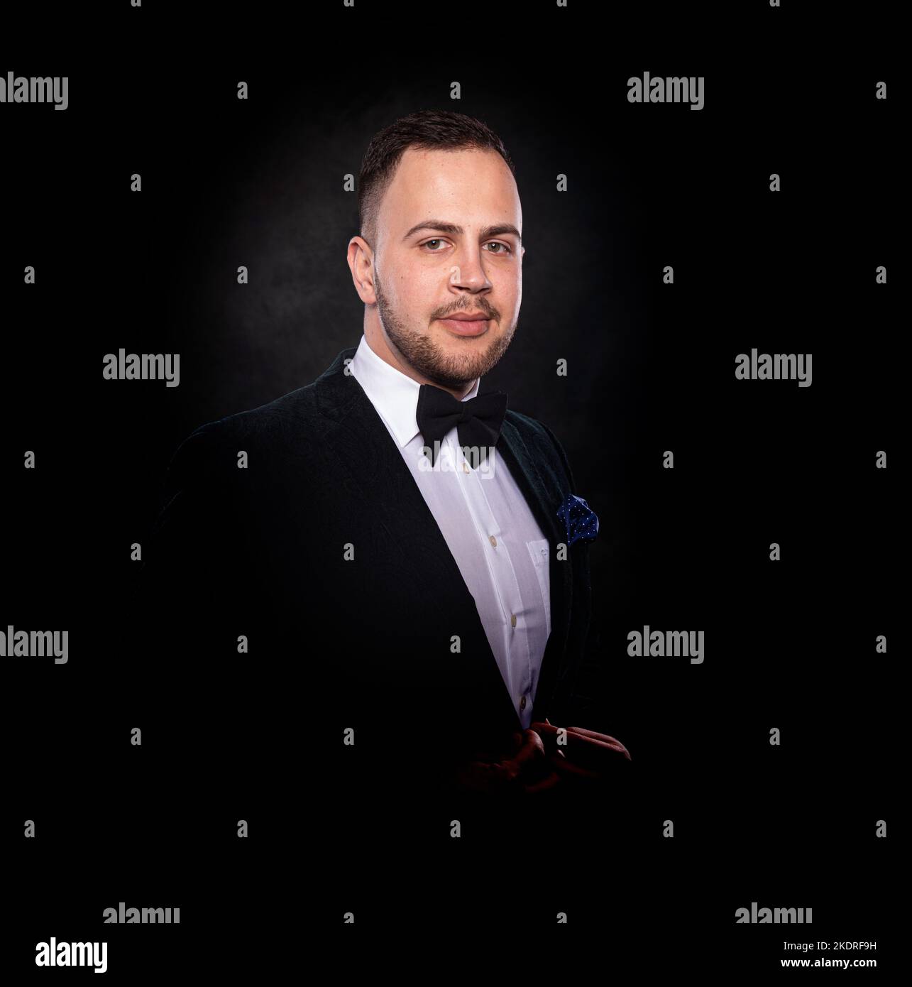 Attractive man with a beard on a dark background Stock Photo - Alamy