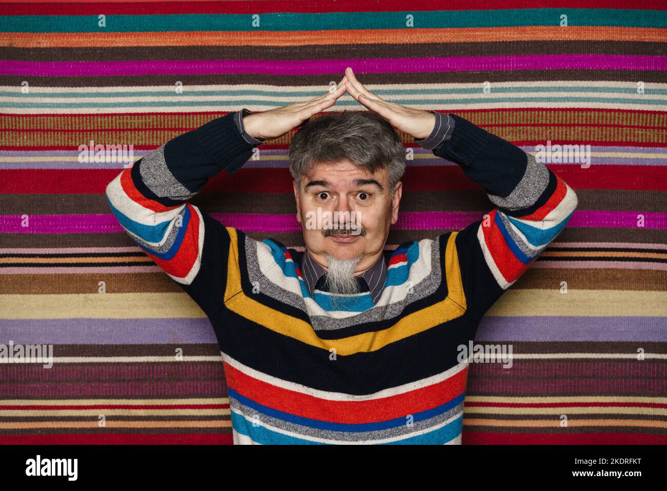 Mature man with grey beard gesturing and looking at camera isolated ...