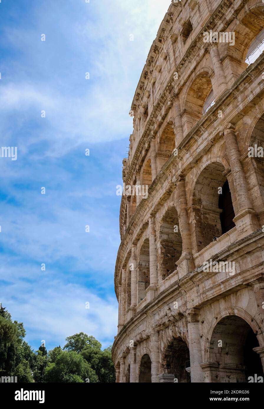 Ancient Coliseum in Rome with fair clouds in blue sky Stock Photo - Alamy