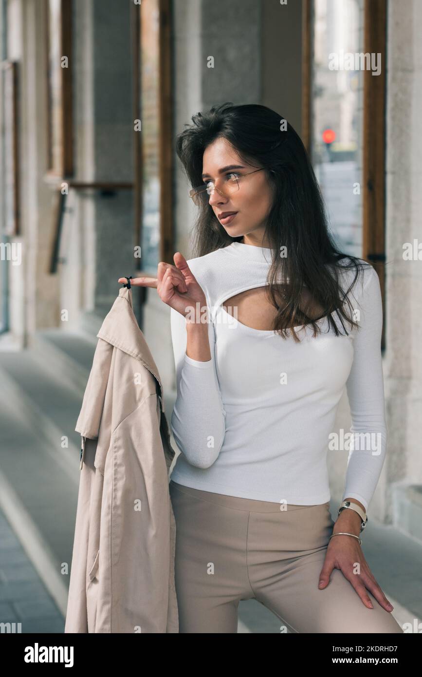 beautiful brunette girl in a sunglasses dressed in white blouse with a ...
