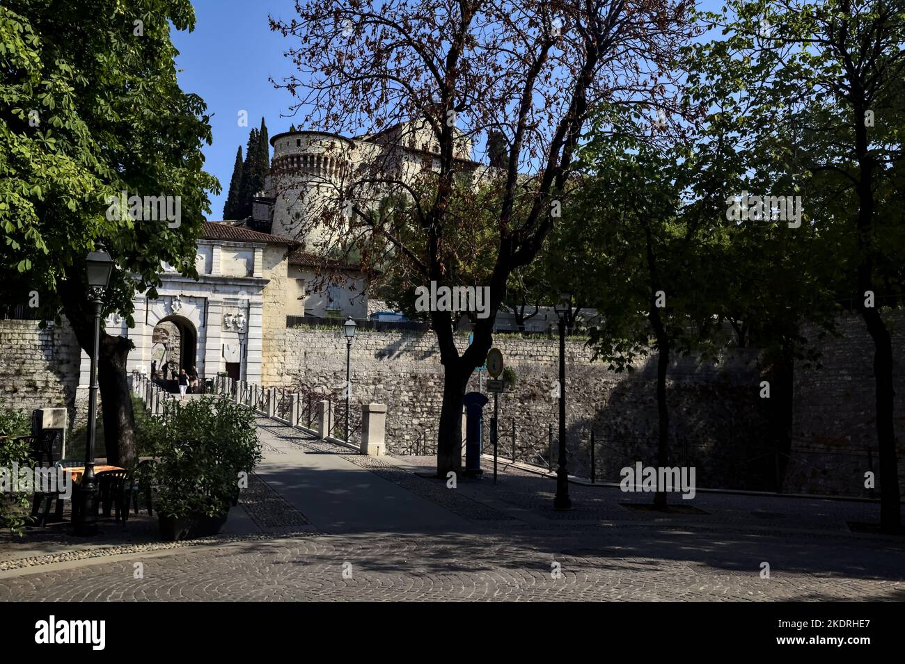 Gate of the Castello di Brescia on a clear day framed by trees Stock ...